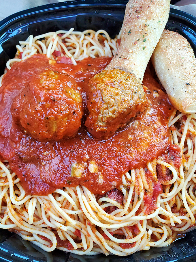 Those meatballs aren't just food; they're edible time machines transporting you straight to Sunday dinner at Nonna's house.