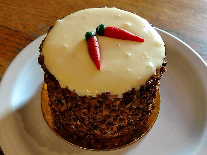 Those candied pecans hugging the sides aren't just decoration&mdash;they're the crunchy bodyguards protecting that impossibly moist carrot interior.