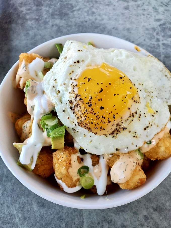 Tater tots graduated from school lunch to culinary masterpiece. That perfectly fried egg on top is like the valedictorian's speech&mdash;the crowning achievement.