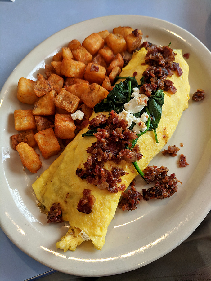 This omelet doesn't just contain ingredients &ndash; it showcases them, like a delicious gallery opening where spinach and bacon are the stars.
