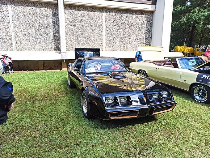 Automotive history meets outdoor exhibition. This vintage fire engine's cherry-red finish pops against the museum's distinctive architecture like a Norman Rockwell painting come to life.