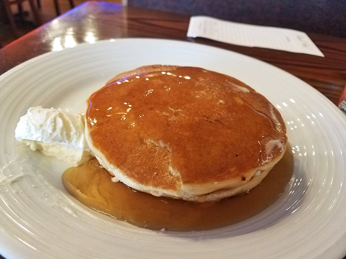 The platonic ideal of a pancake&mdash;golden, fluffy, and swimming in syrup that catches the light like liquid amber. This is breakfast royalty.