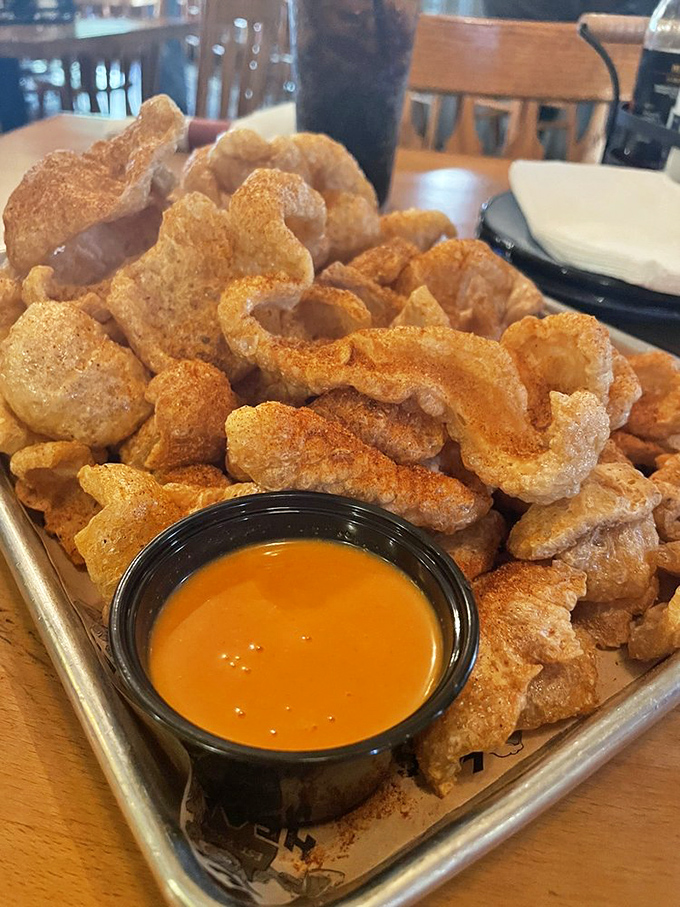 Golden pork rinds that crackle with each bite, served with a dipping sauce that makes you wonder why you'd eat them any other way.