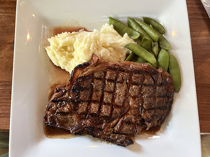 The kind of prime rib that makes conversation stop mid-sentence, accompanied by green beans and potatoes that know their supporting role perfectly.