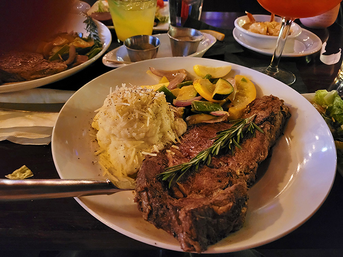 Your plate is filled with a hearty steak, creamy mashed potatoes, and colorful vegetables for a truly satisfying evening meal.