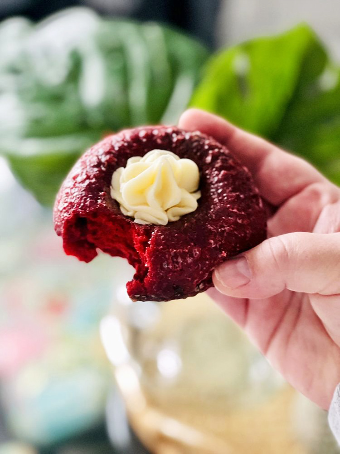 Someone took a bite of this red velvet donut and found cream cheese frosting inside&mdash;proof that sometimes inner beauty really does match the exterior.