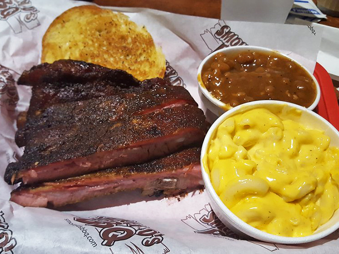 The holy trinity of BBQ bliss: ribs with that perfect bark, cornbread that's not an afterthought, and sides that deserve their own fan club.