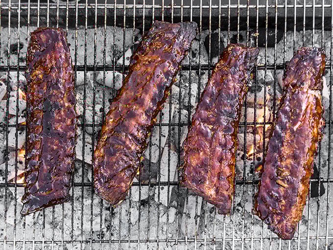 Ribs lacquered to glossy perfection, lined up like edible art. This is what barbecue dreams are made of, folks.