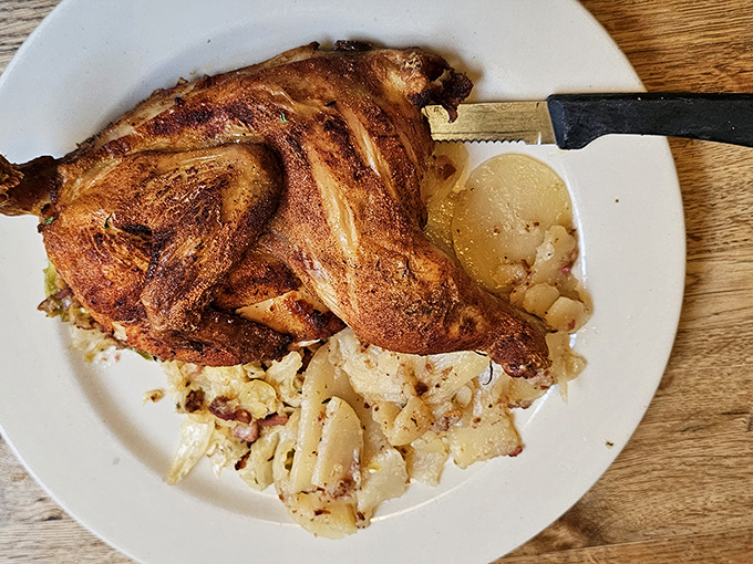 Golden roasted chicken resting on a bed of potato salad&mdash;proof that sometimes the simplest combinations create the most profound happiness.