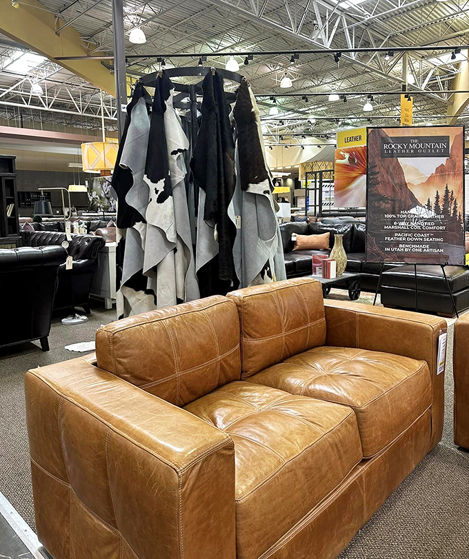 Premium leather hides on display near a caramel-colored loveseat that looks like it belongs in a Texas oil baron's study.
