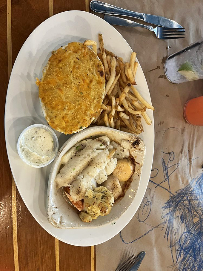 A seafood trinity &ndash; perfectly broiled fish, golden crab cake, and potatoes that received the memo about not being mere side characters.