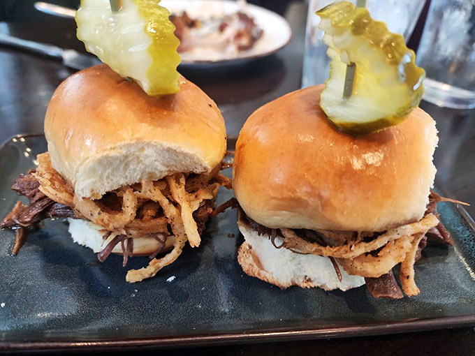 Sliders that make you question why regular-sized sandwiches even exist &ndash; perfect bites of tender meat with crispy onion crowns.
