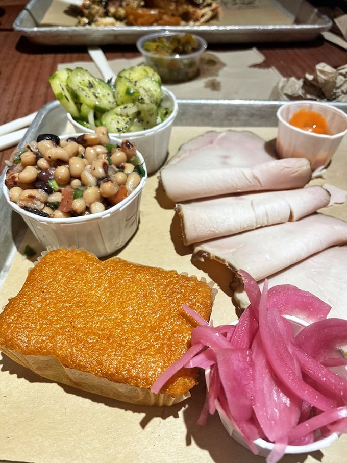 Sliced turkey that defies the "dry poultry" stereotype, accompanied by sides that refuse to be mere afterthoughts.