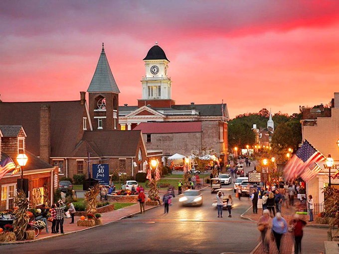 As dusk falls, Jonesborough's Main Street comes alive with twinkling lights and festival-goers, the courthouse clock tower standing sentinel over the revelry below.
