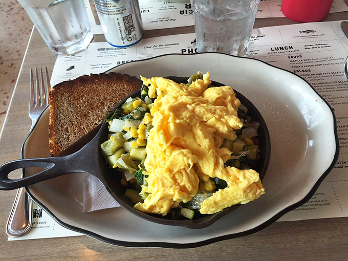 Garden-fresh vegetables dancing beneath perfectly scrambled eggs. Proof that "eating your veggies" can be the highlight of your day rather than childhood punishment.