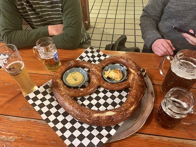 Two small ramekins of mustard stand guard like sentinels protecting the pretzel mothership. Resistance is futile, just surrender to carb heaven.