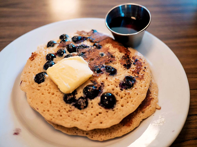 Blueberry pancakes topped with a pat of butter slowly melting into breakfast nirvana. The maple syrup awaits its supporting role.