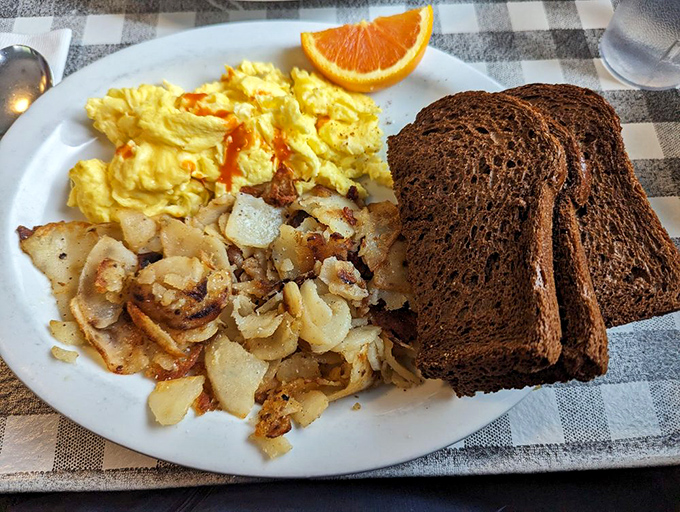 The breakfast trinity: perfectly scrambled eggs, golden hash browns, and toast dark enough to make a difference. Simple pleasures executed flawlessly.