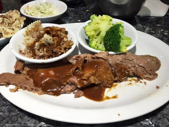 Brisket so tender it surrenders to your fork without a fight, swimming in gravy that deserves its own fan club.
