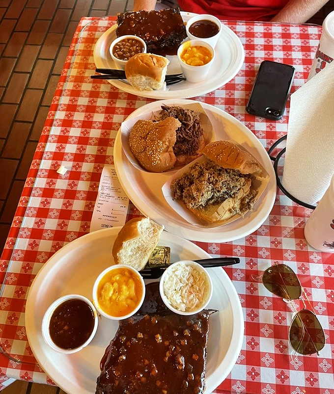 BBQ spread that would make a vegetarian question their life choices. Three plates, two people, zero regrets&mdash;math works differently when barbecue is involved.
