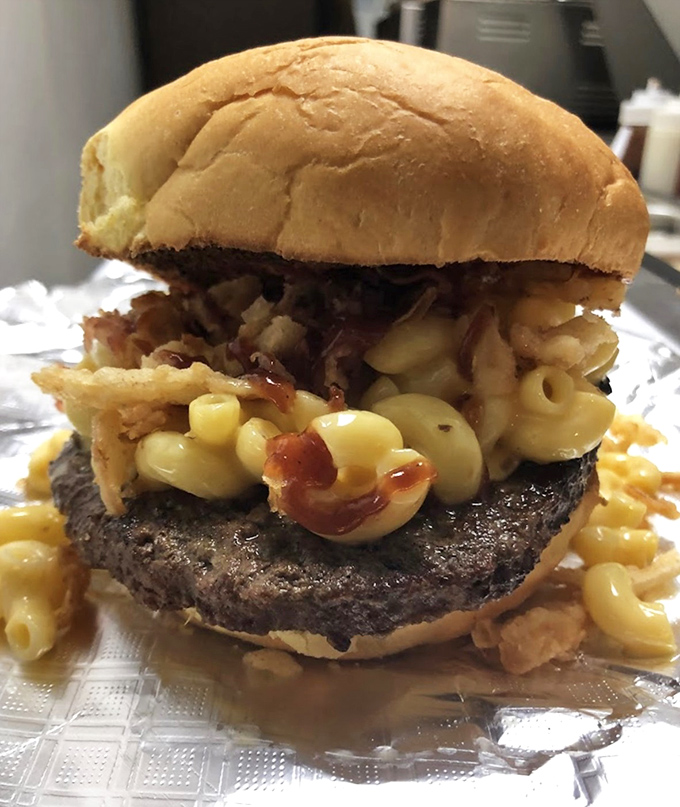 This isn't just a burger – it's a declaration that mac and cheese belongs everywhere, including atop your beef patty. Revolutionary stuff, people.