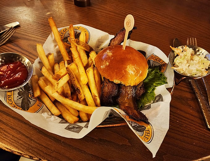 This isn't just a burger, it's an architectural masterpiece of beef, bacon, and golden fries that demands to be photographed before devoured.