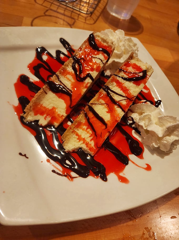 Cheesecake that dresses for the occasion, with strawberry sauce and chocolate drizzle playing the roles of prom king and queen.