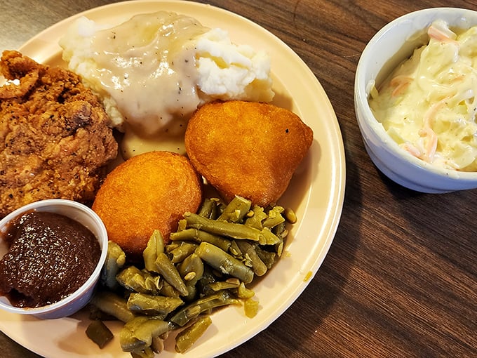 A plate that speaks the universal language of comfort &ndash; crispy fried chicken, cornbread hushpuppies, and sides that make you feel like family.