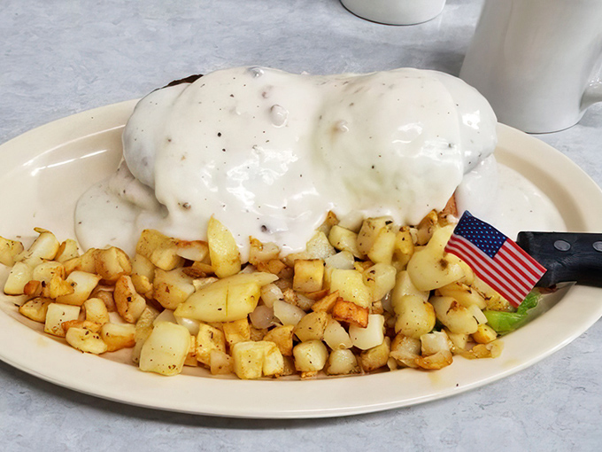 Breakfast potatoes crisped to golden perfection alongside what appears to be a country-fried delight&mdash;this plate doesn't just feed you, it hugs you from the inside.