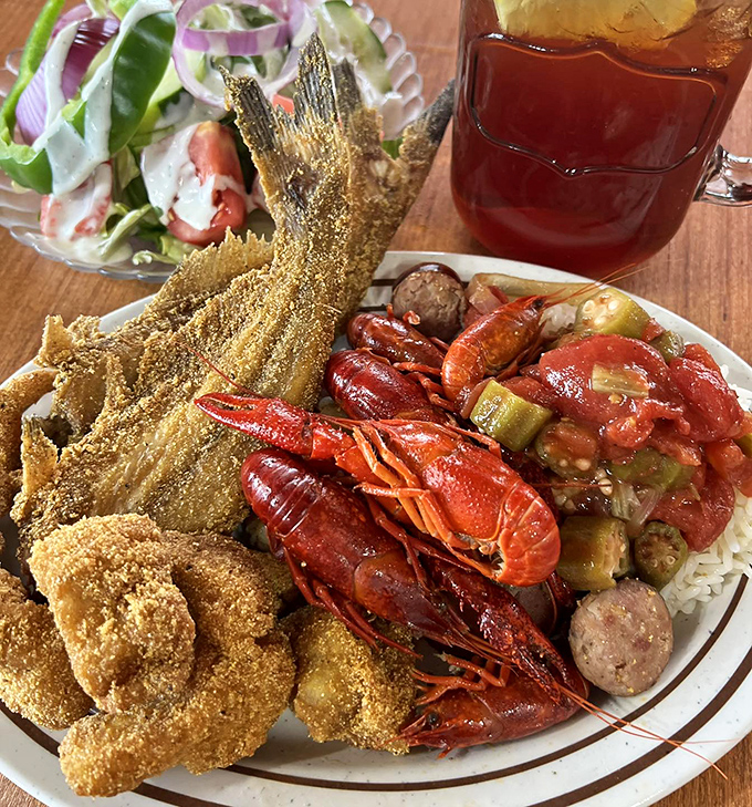 Seafood heaven on a plate! Crispy cornmeal-crusted fish, crawfish ready for their close-up, and a salad pretending to make this a balanced meal.