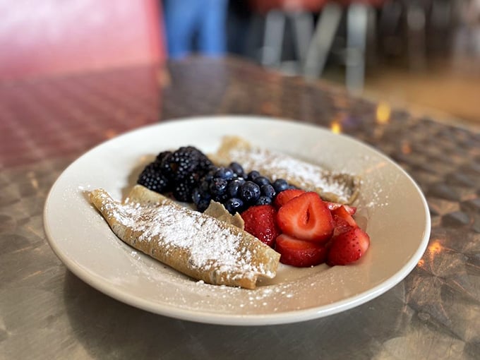 Delicate crepes adorned with fresh berries and a dusting of powdered sugar. Breakfast or dessert? The beauty is you don't have to choose.