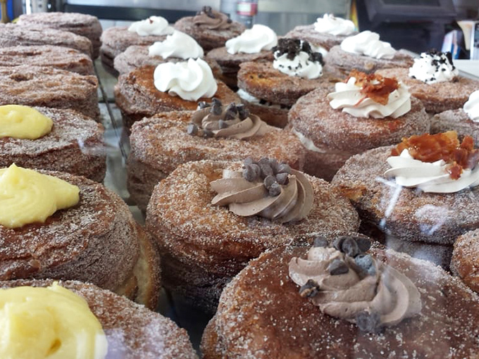 A battalion of cinnamon-sugar cronuts standing at attention, each topped with its own crown of creamy goodness. Resistance is futile.
