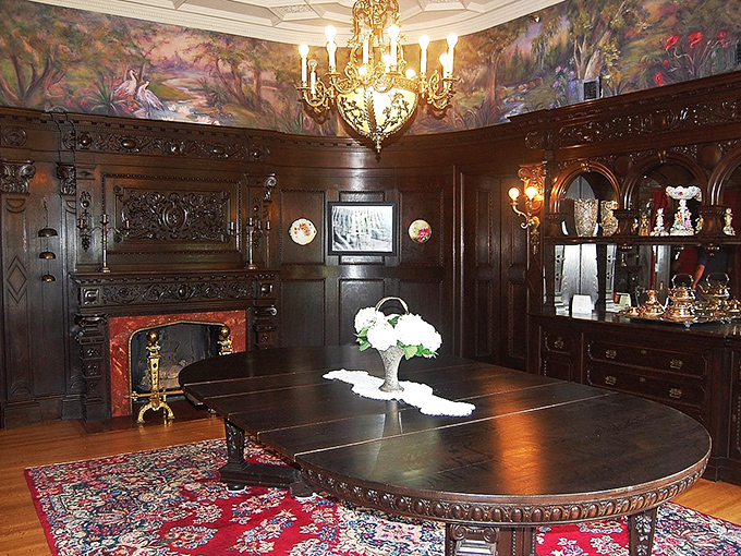 The dining room's dark paneling and ornate fireplace scream "important conversations happened here." That table has probably hosted more distinguished guests than a presidential state dinner.