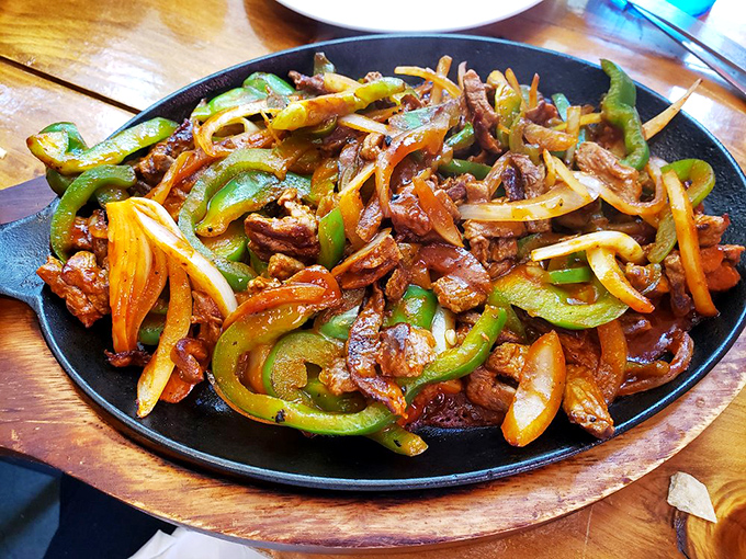 Sizzling fajitas that announce their arrival before you see them. The peppers and onions dancing with the meat is dinner theater at its finest.