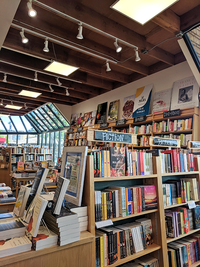 The fiction section: where wooden shelves strain under the weight of worlds waiting to be discovered, organized with the care of literary matchmakers.