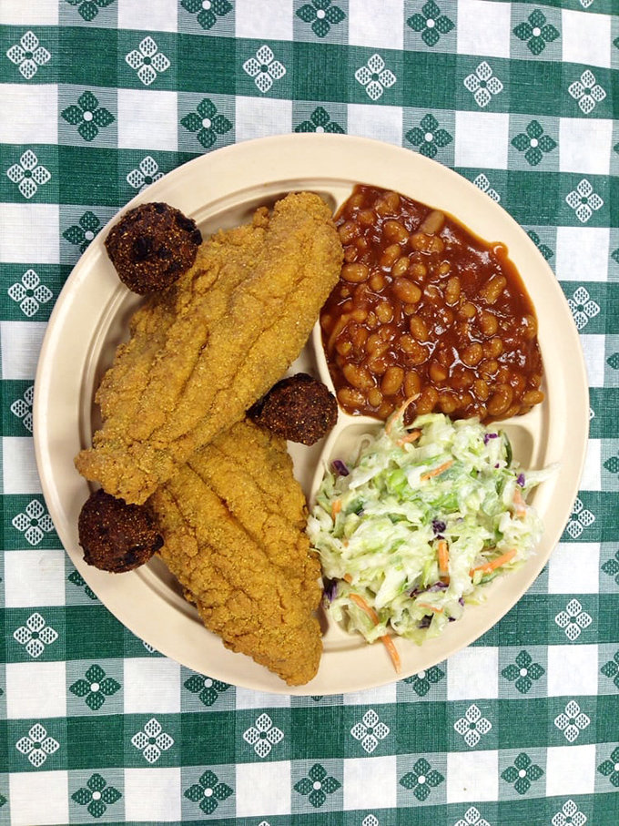 Golden-crusted catfish flanked by baked beans and coleslaw—a trio that performs together better than The Supremes in their prime.