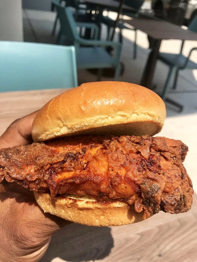 Not all heroes wear capes; some wear crispy batter that extends gloriously beyond the bun. This sandwich means business.