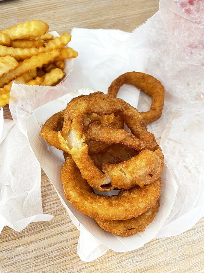 Golden rings of happiness stacked like delicious edible jewelry. Onion rings this perfect are worth every napkin you'll need afterward.
