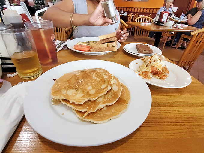 Stack of pancakes that would make your grandmother proud. These golden discs aren't just breakfast&mdash;they're edible sunshine on a plate.