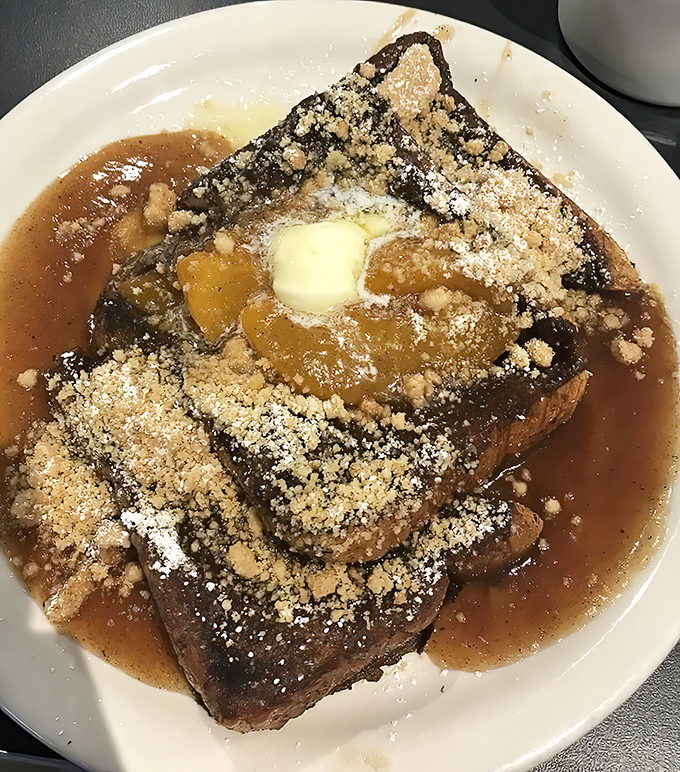 The legendary Peach Cobbler French Toast in all its glory. Georgia's state fruit having its Oscar-worthy moment atop custard-soaked bread.