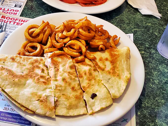 Quesadilla meets curly fries in a cross-cultural plate romance that would make United Nations diplomats proud.