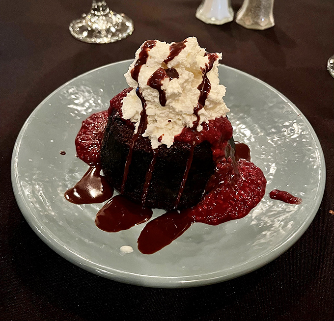Chocolate cake so decadent it should require a permission slip. That whipped cream crown isn't garnish—it's necessary emotional support.