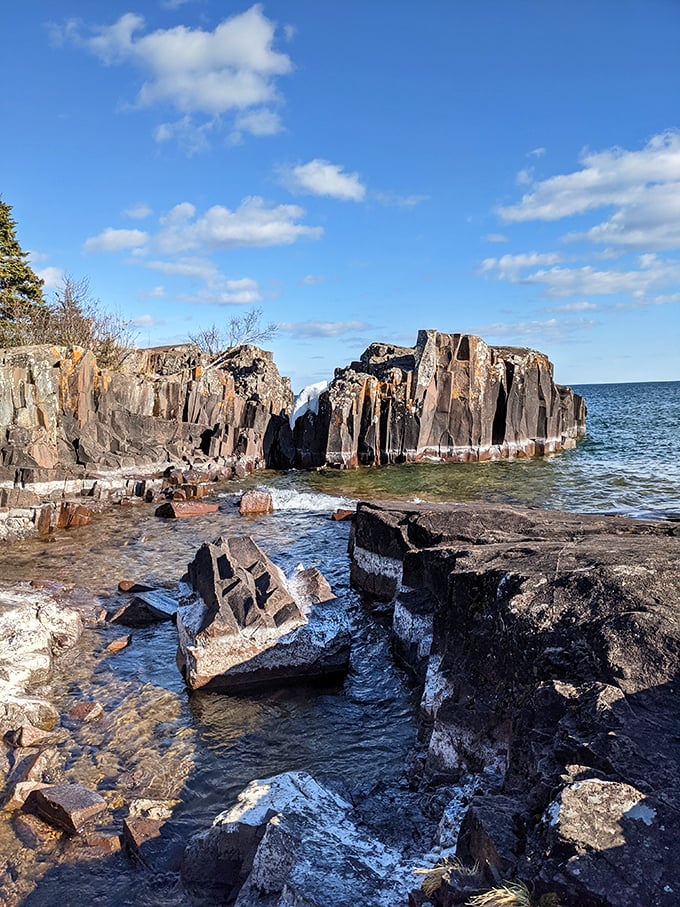 Nature's sculpture garden emerges from Superior's waters, these ancient rock formations shaped by billions of icy waves and countless sunrises.