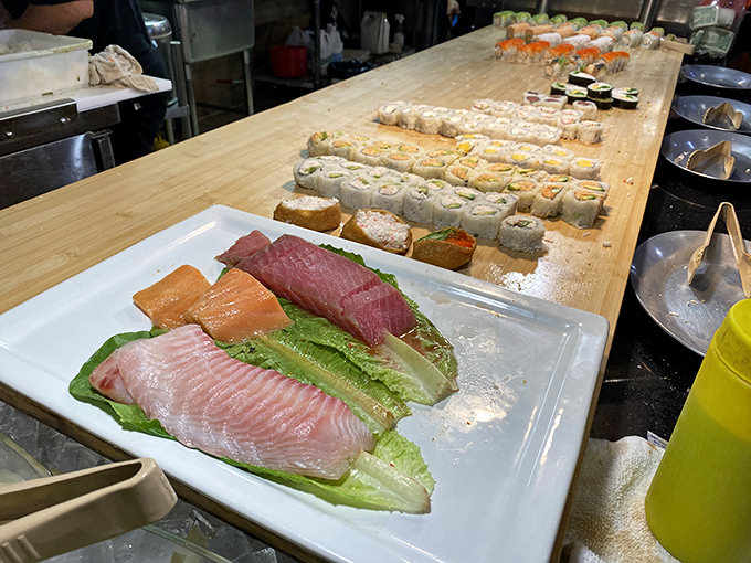 Sashimi artfully arranged is the buffet's quiet sophistication. These ocean jewels deserve their own moment of silence before the inevitable chopstick dance begins.
