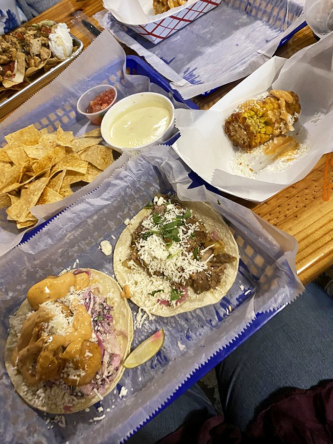 One drizzled with sauce, one topped with fresh pico &ndash; it's the taco version of fraternal twins, both equally deserving of your immediate attention.