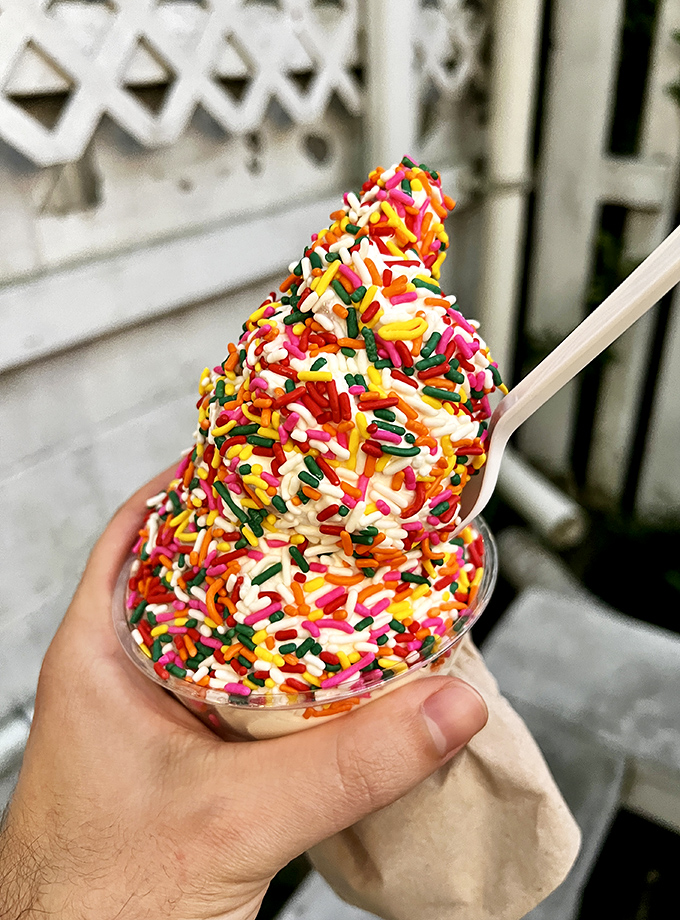 Sprinkle therapy in action! This rainbow-topped creation proves everything in life is better when covered in tiny, colorful sugar sticks.