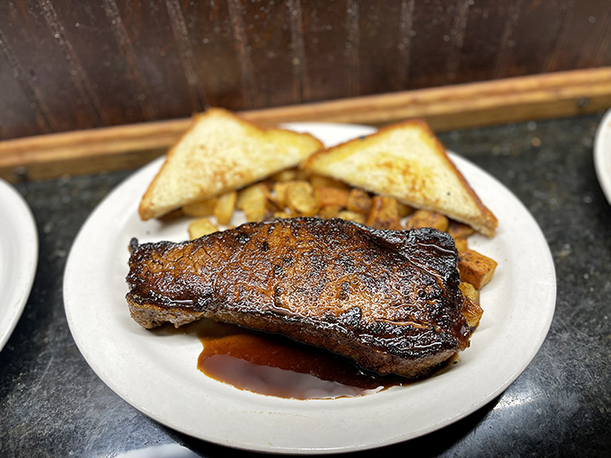 A steak so perfectly seared it makes you question every other steak you've ever eaten. The Texas toast is just there to soak up your tears of joy.