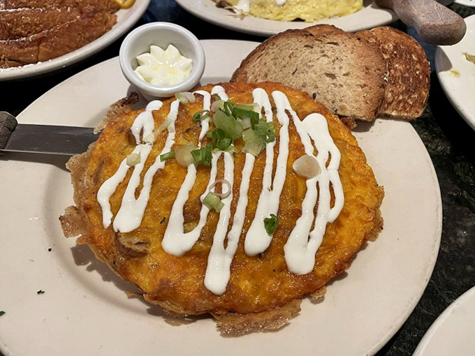 Cheese pulls for days! This golden frittata draped in creamy sauce is what breakfast dreams are made of&mdash;comfort food wearing its Sunday best. 