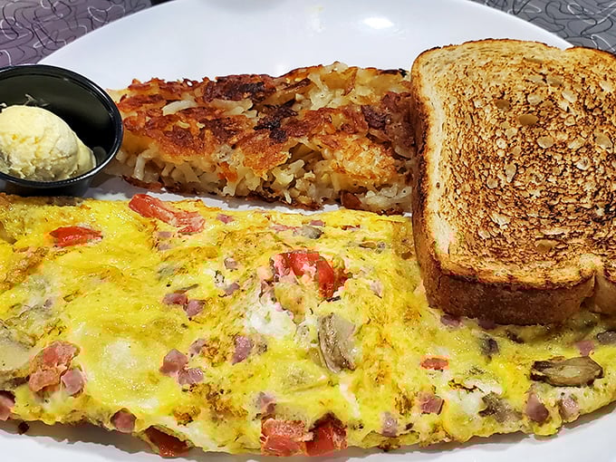 This isn't just an omelet&mdash;it's a masterpiece of ham, cheese, and vegetables tucked inside fluffy eggs, with perfectly golden toast standing guard.