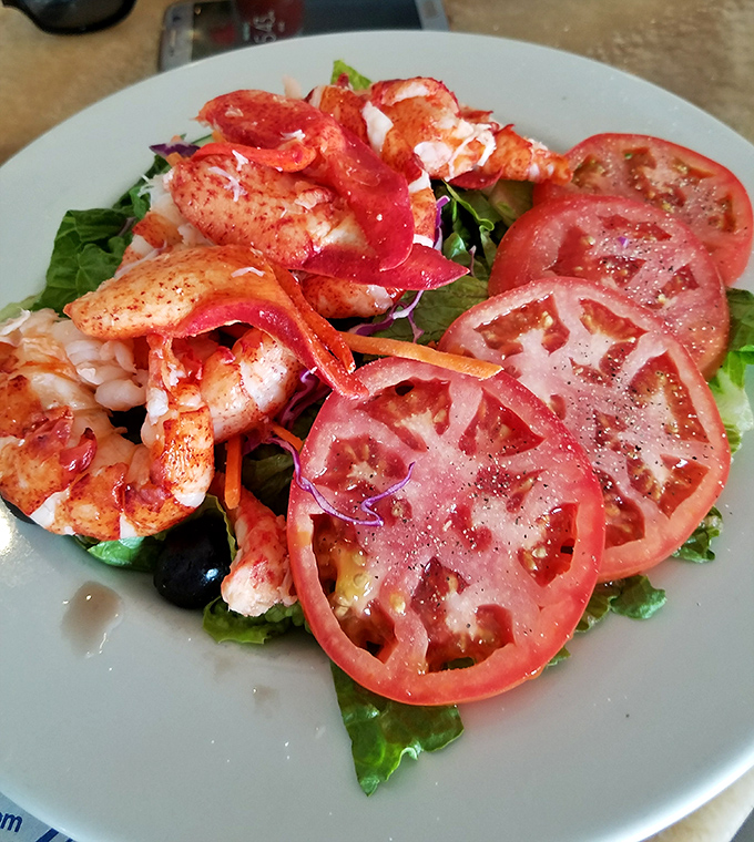 Summer on a plate – plump, perfectly cooked shrimp nestled among garden-fresh tomatoes and greens, a refreshing counterpoint to fried favorites.
